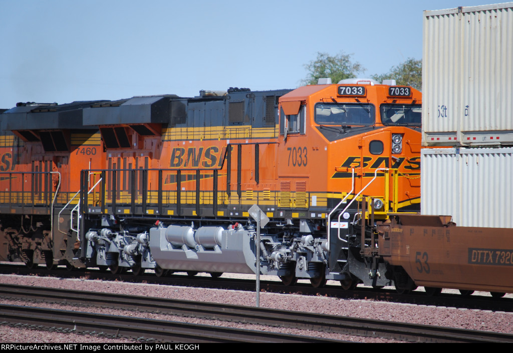 BNSF 7033 is the 2 unit behind BNSF 7460 as they pull a Stack Train on the Jewel connector track ...